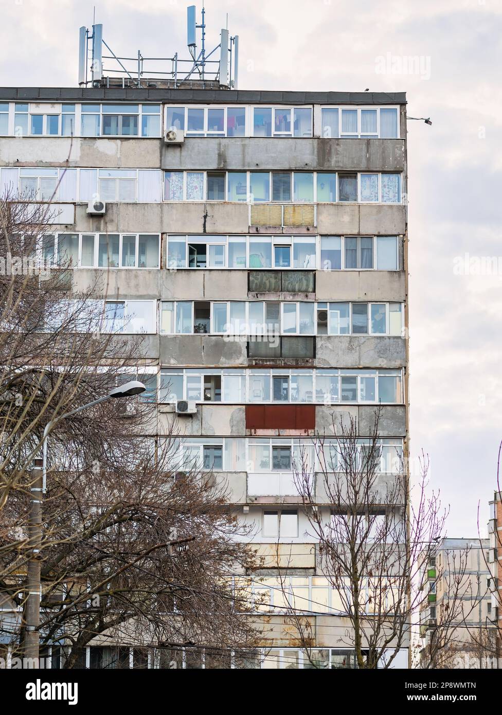 Worn out apartment building from the communist era against blue sky in ...