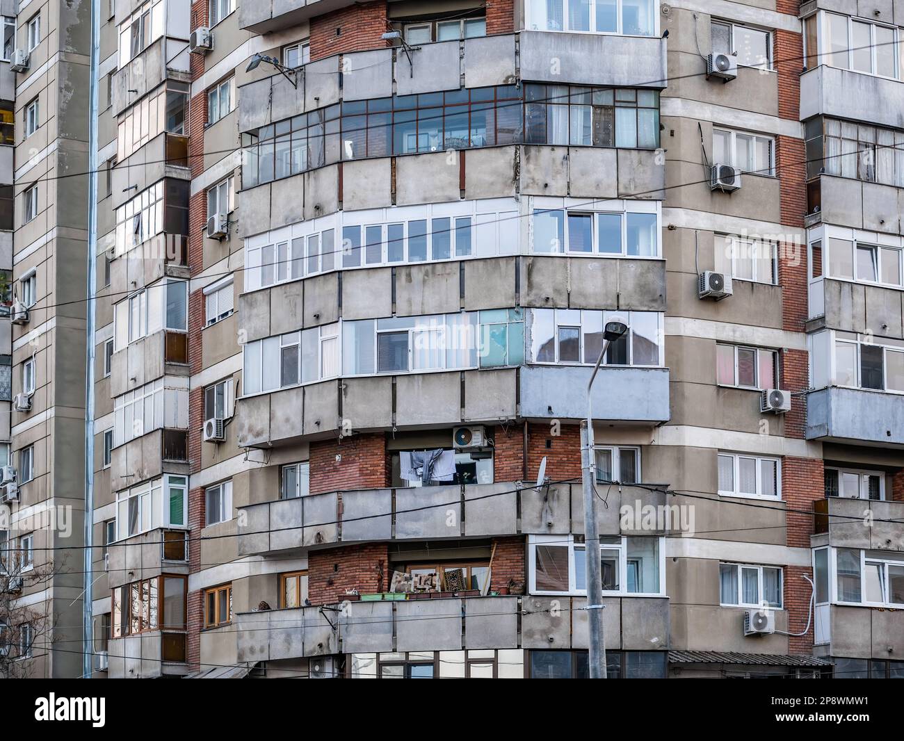 Worn out apartment building from the communist era against blue sky in ...