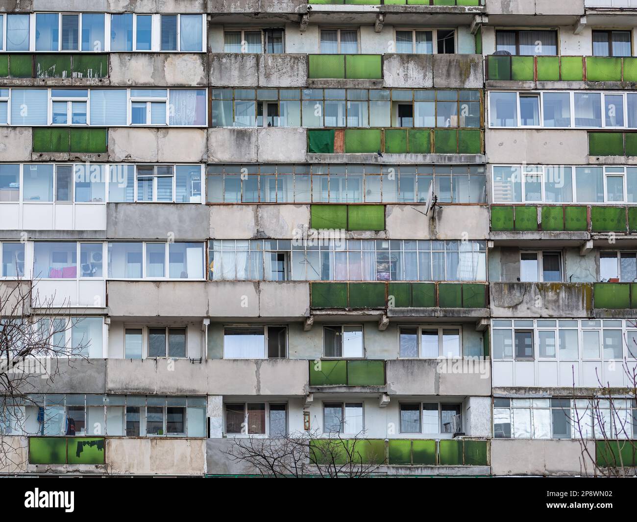 Worn out apartment building from the communist era against blue sky in ...