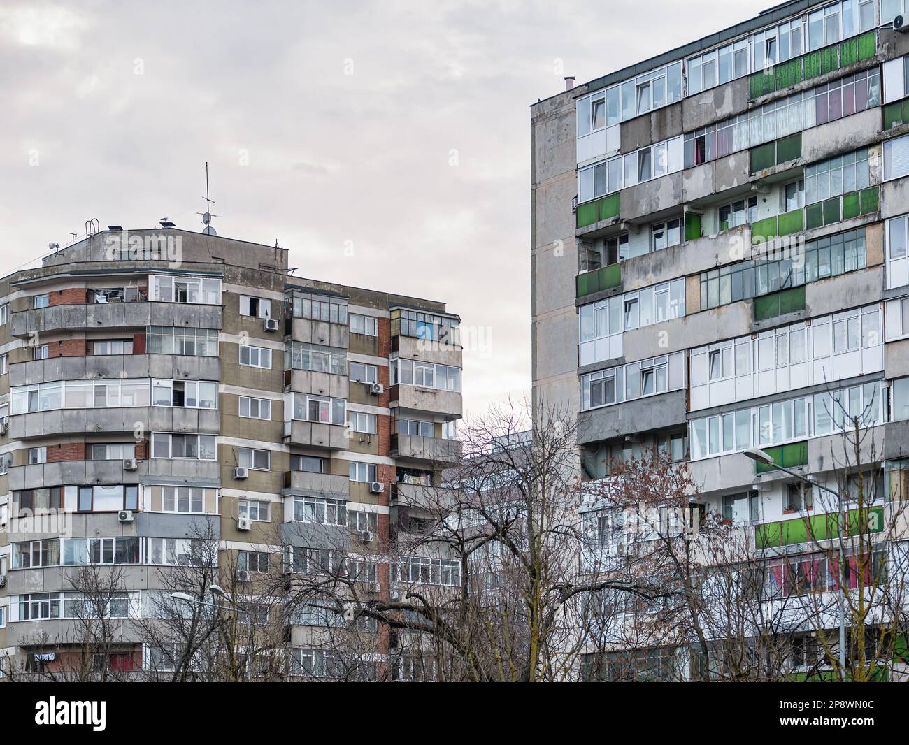 Worn out apartment building from the communist era against blue sky in ...