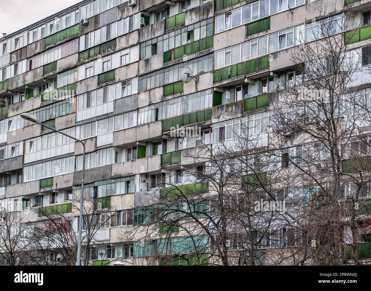 Worn out apartment building from the communist era against blue sky in ...