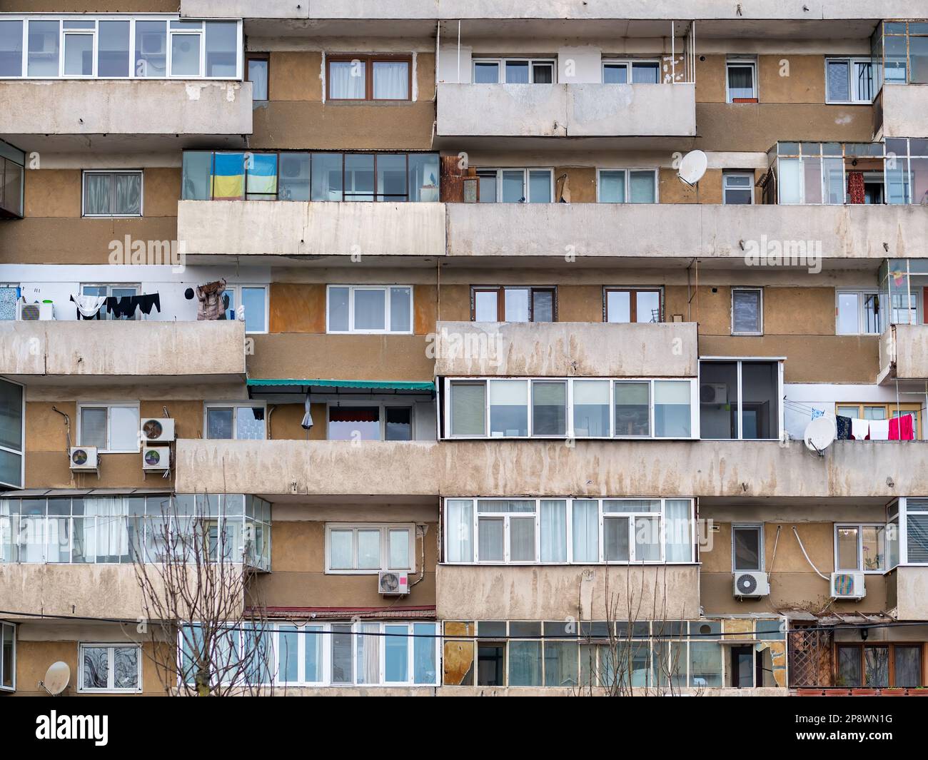 Worn out apartment building from the communist era against blue sky in ...