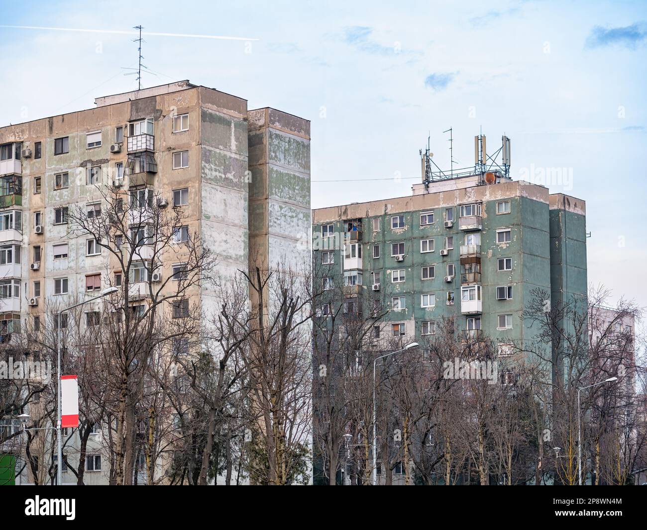 Worn out apartment building from the communist era against blue sky in ...