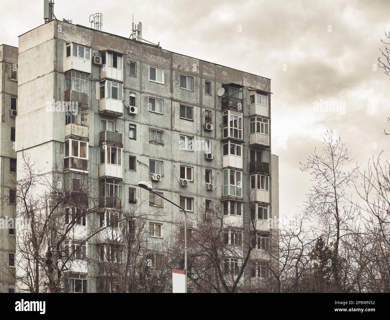 Worn out apartment building from the communist era against blue sky in ...