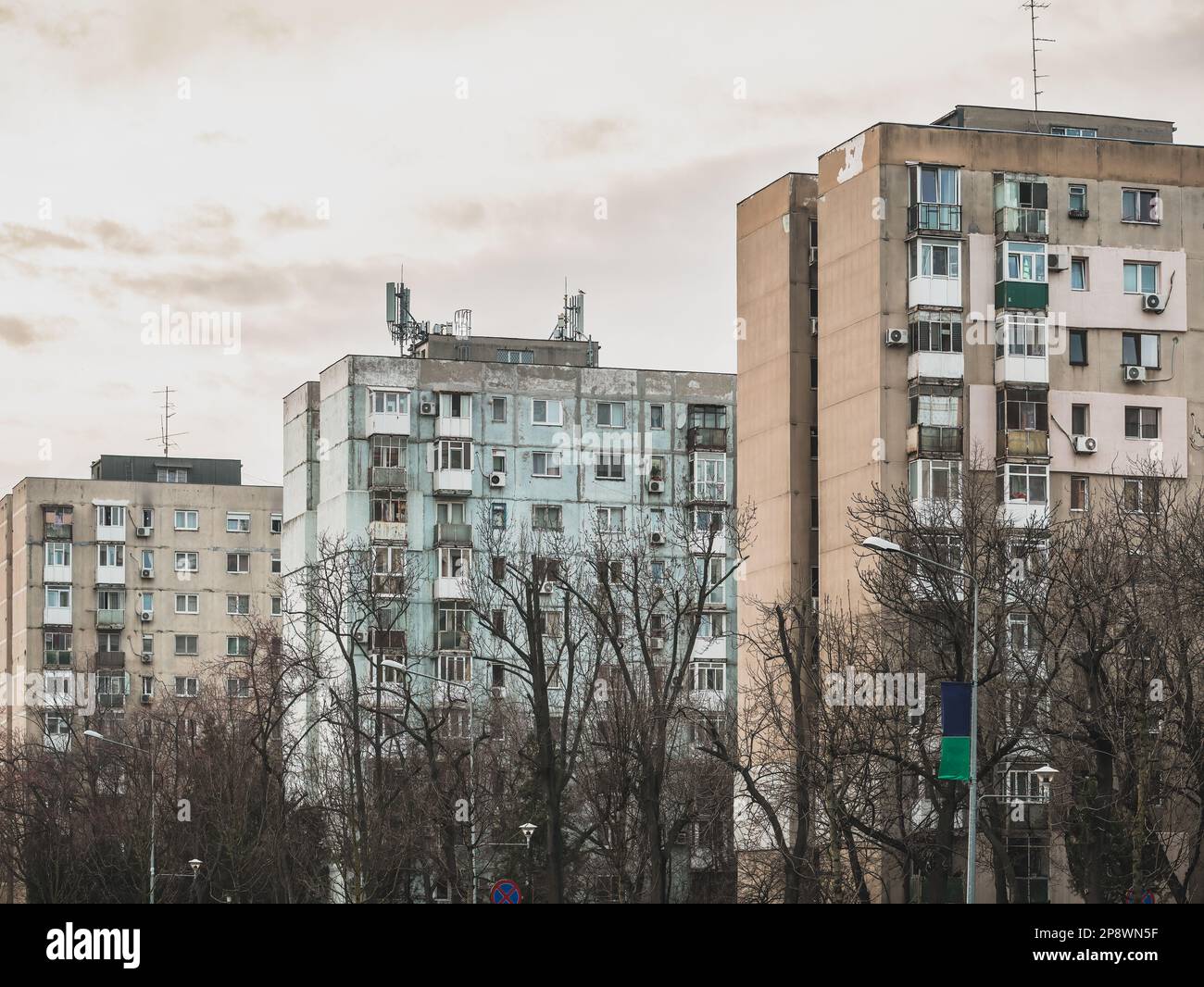 Worn out apartment building from the communist era against blue sky in ...