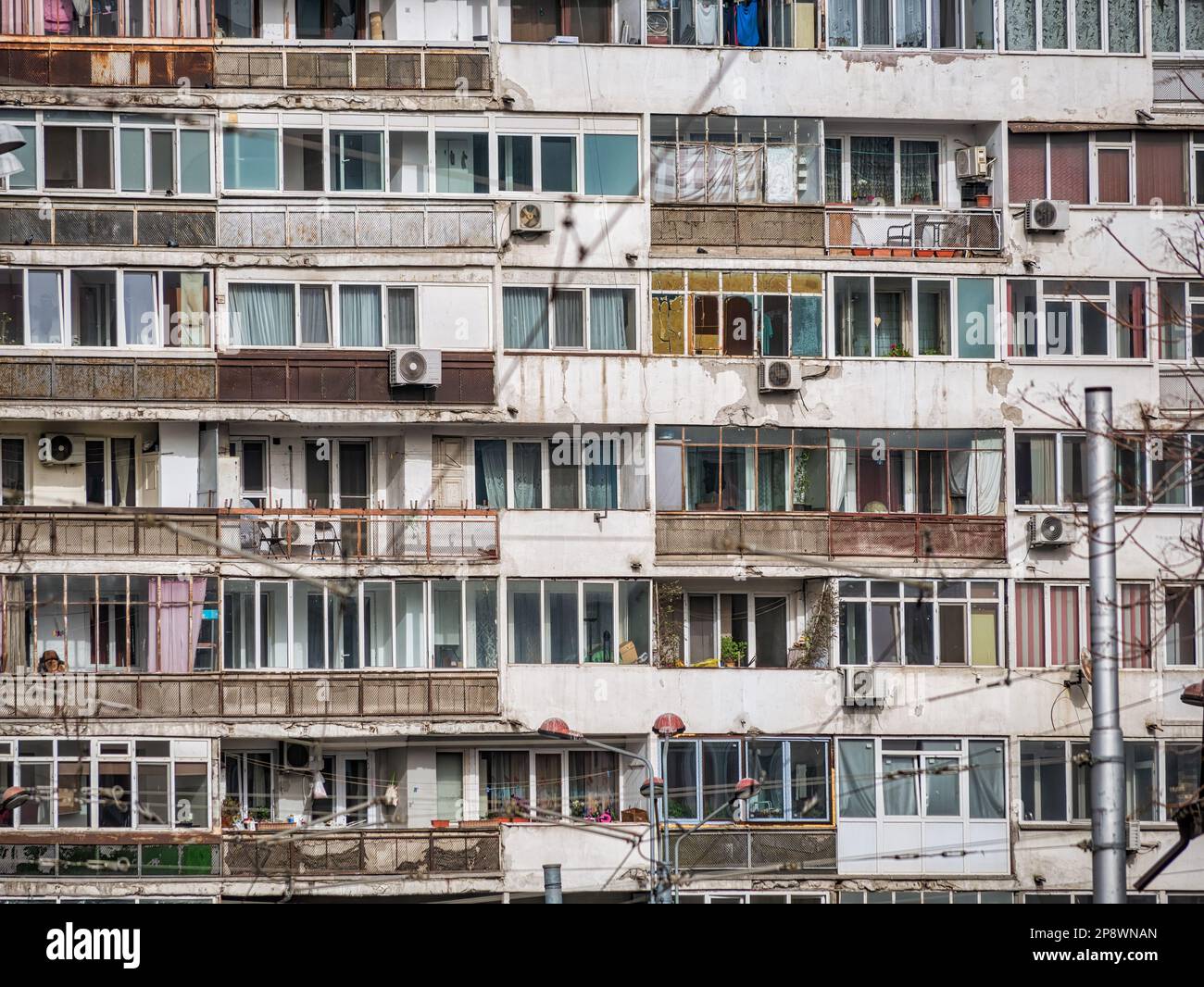 Worn out apartment building from the communist era against blue sky in ...