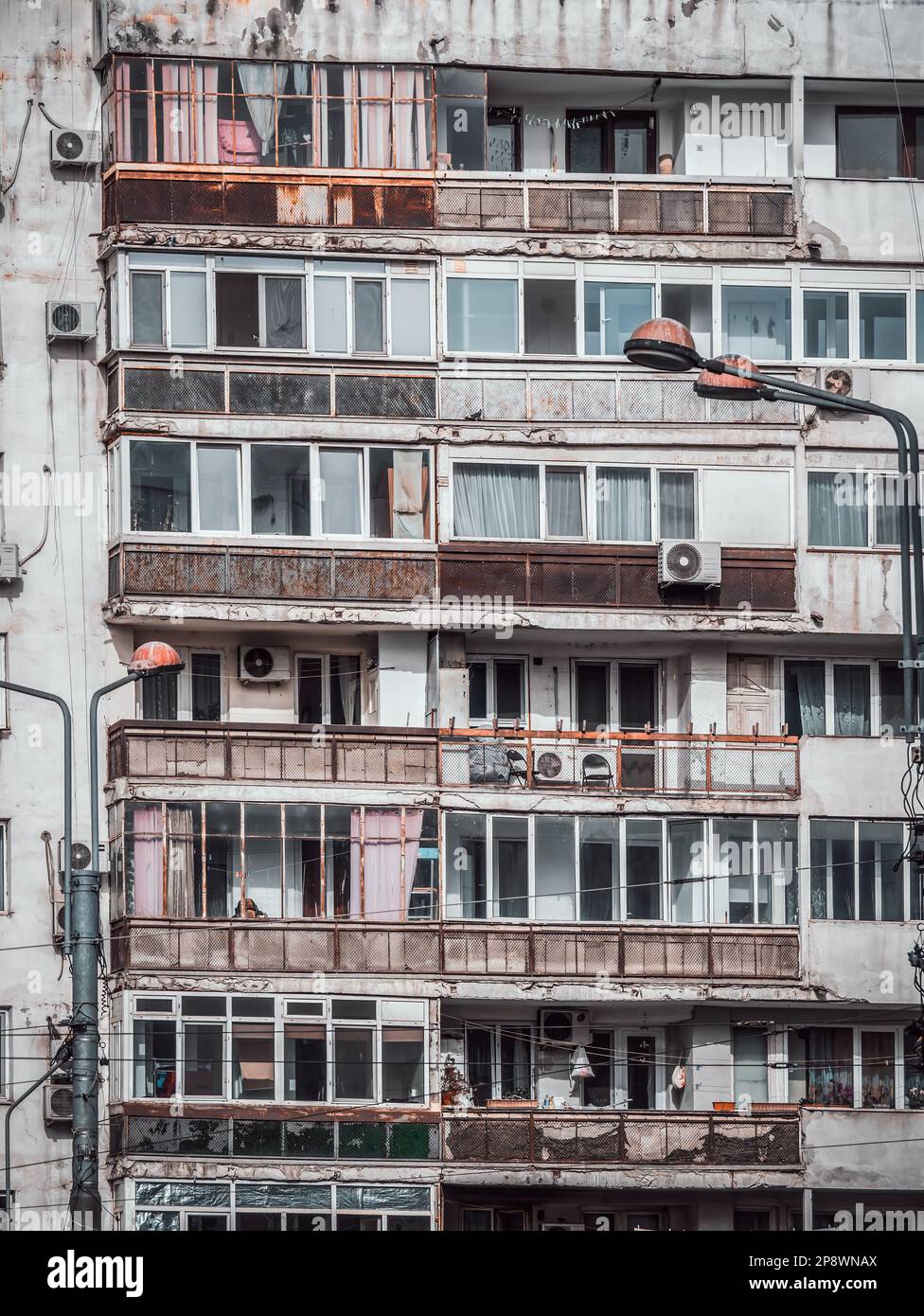Worn out apartment building from the communist era against blue sky in ...