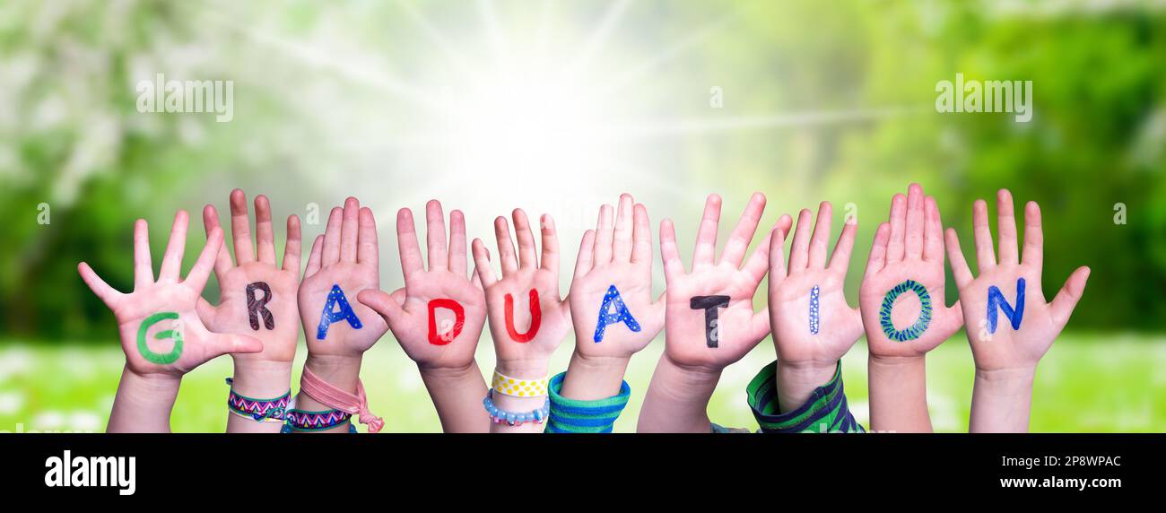 Children Hands Building Word Graduation, Grass Meadow Stock Photo - Alamy