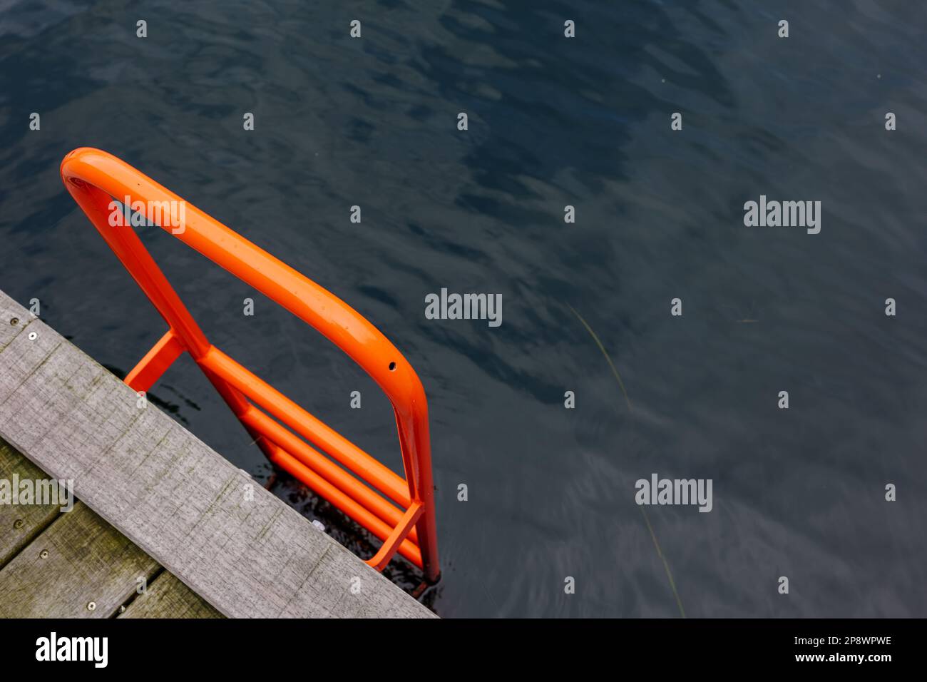 Selective focus at orange dock ladder and wooden floor over water Stock ...