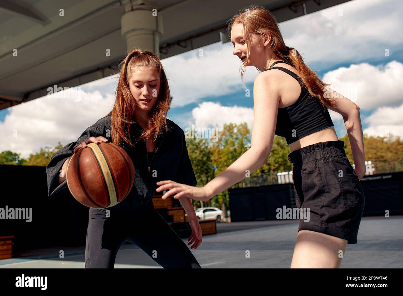 Bonding Through Basketball: Two Friends on court Stock Photo - Alamy