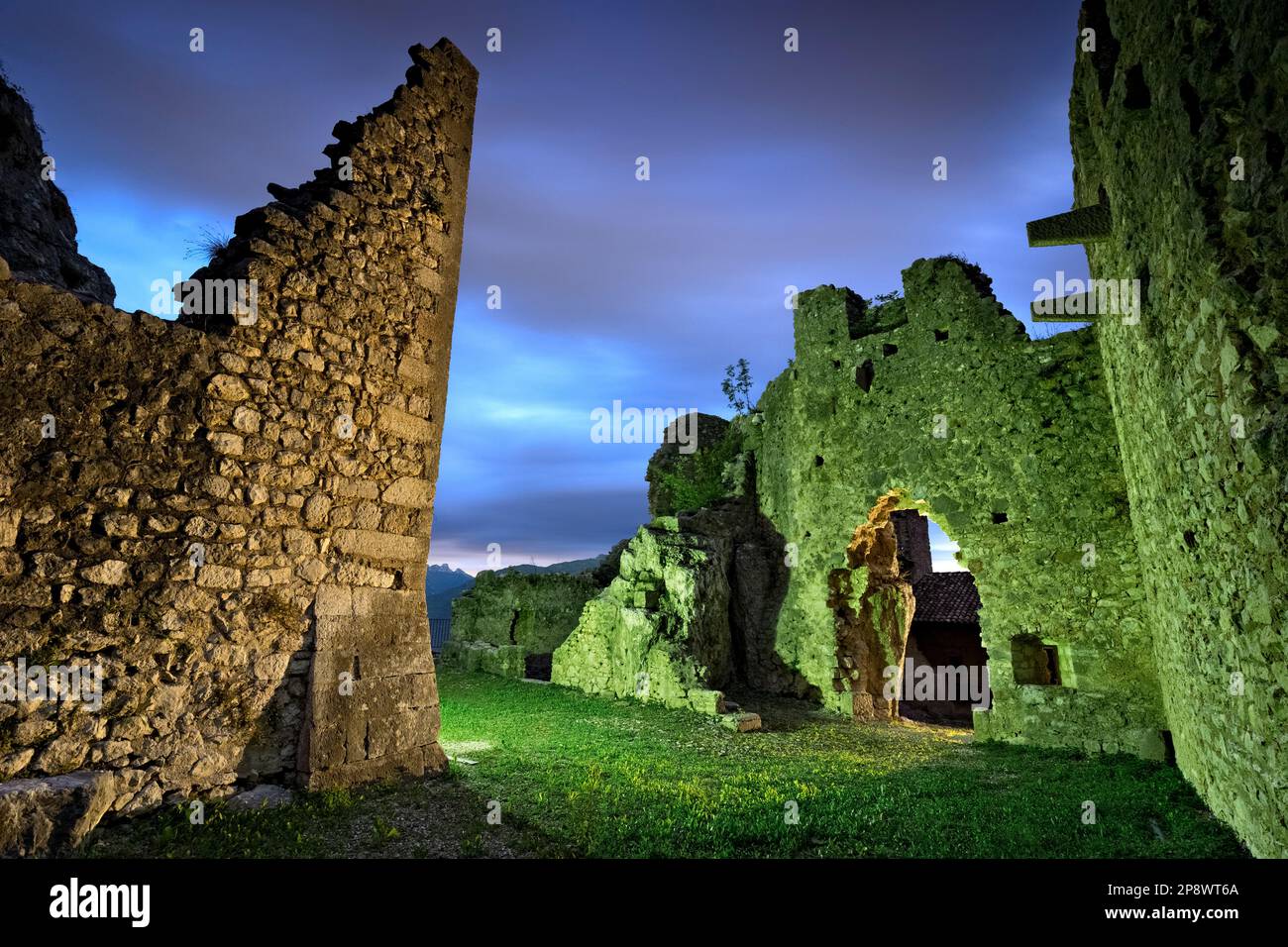 The portal of the mysterious medieval walls of Corno castle at night ...