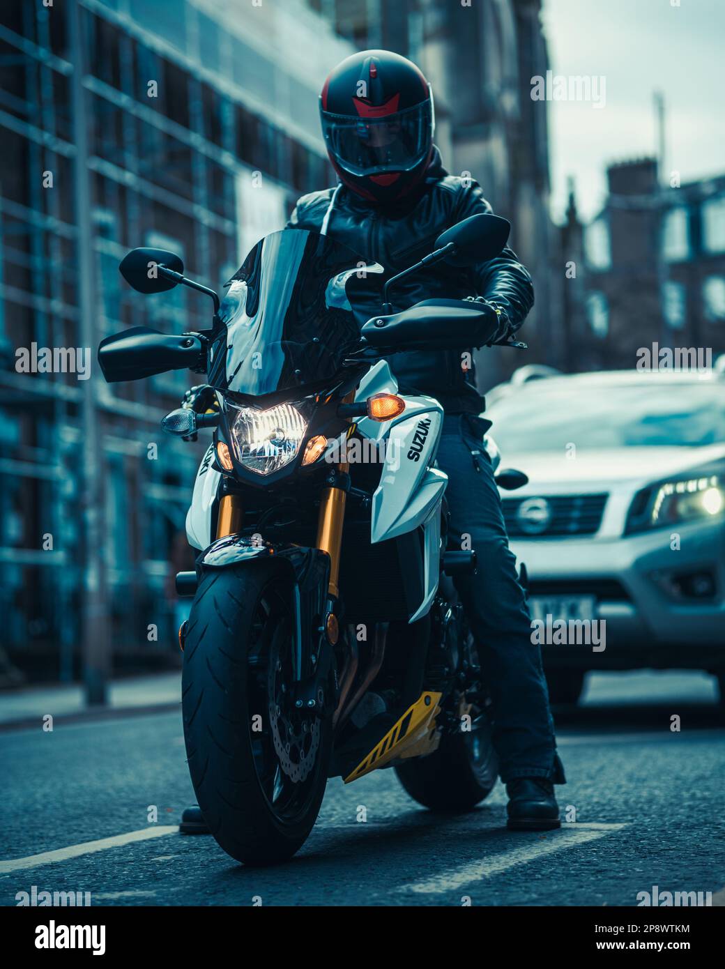A motorbiker caught at traffic lights in Dundee Stock Photo - Alamy