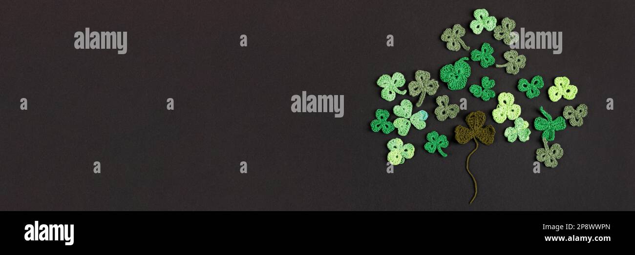 St Patrick's Day concept. Composition made of knitted green shamrocks ...