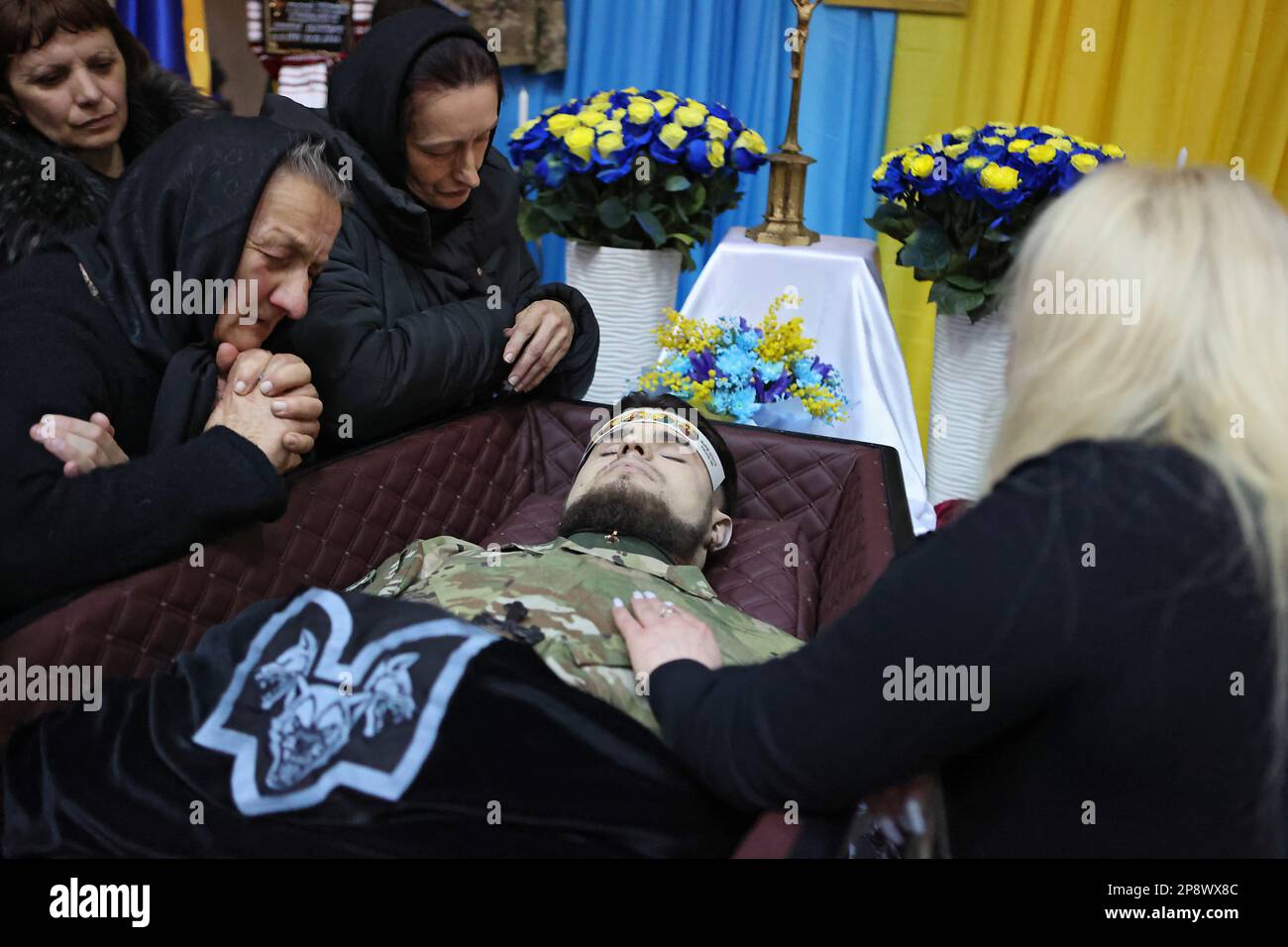 IVANO-FRANKIVSK REGION, UKRAINE - MARCH 09, 2023 - Women weep over the ...