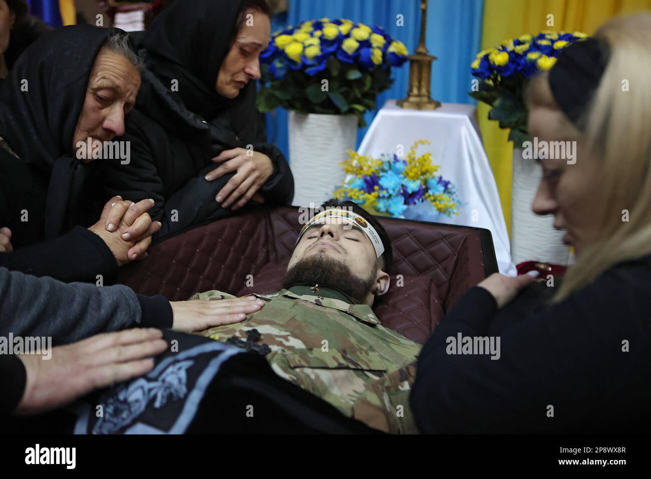 IVANO-FRANKIVSK REGION, UKRAINE - MARCH 09, 2023 - Women weep over the ...
