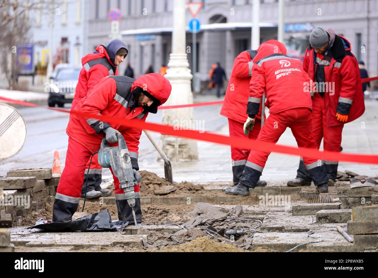 Workers repairing sidewalk surface, worker with jackhammer. Group of ...