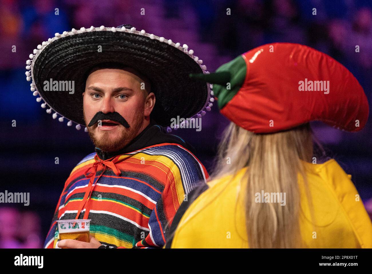 Fans look on in fancy dress during the 2023 Cazoo PDC Premier League ...