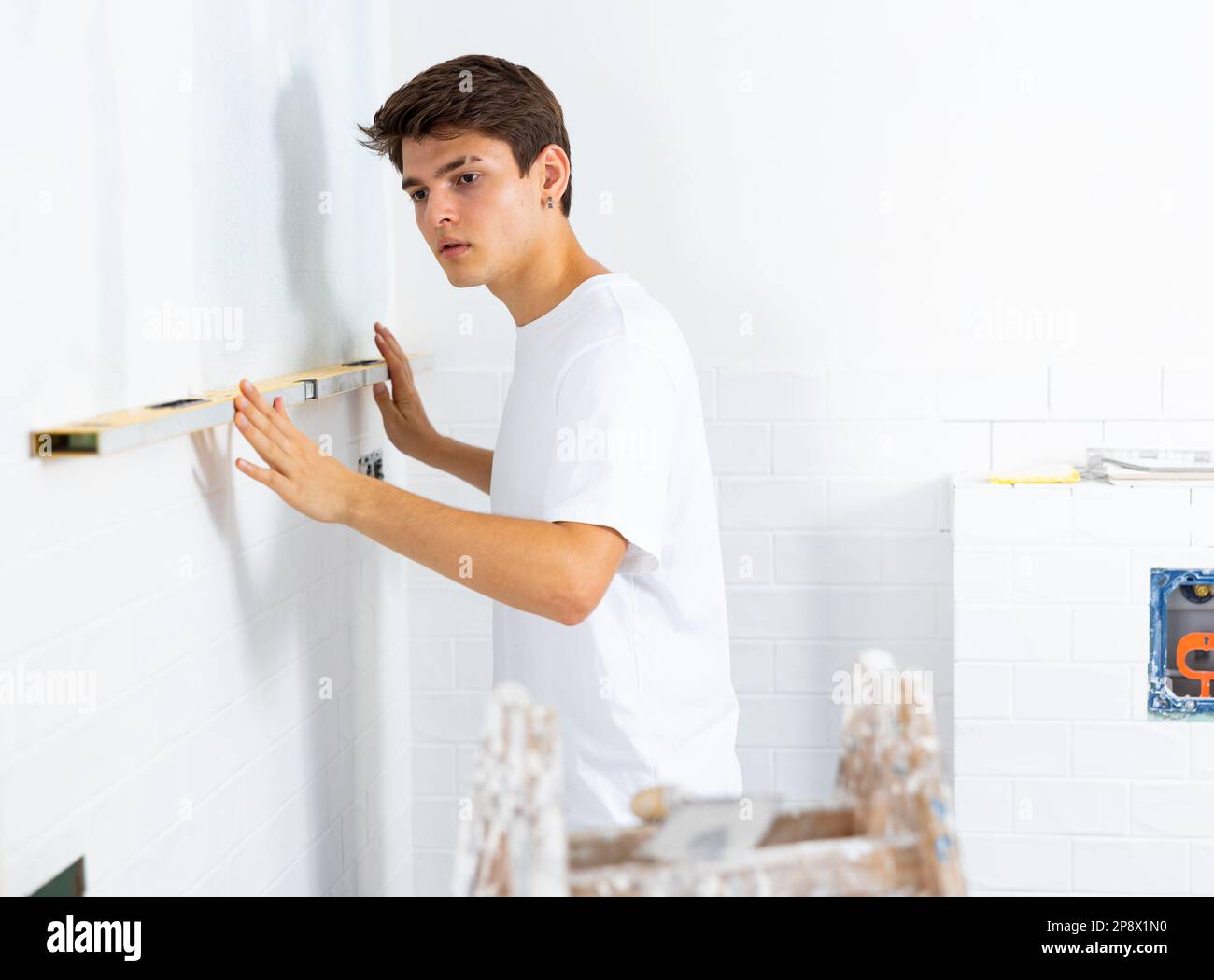 Worker checking level laying tiles hi-res stock photography and images ...