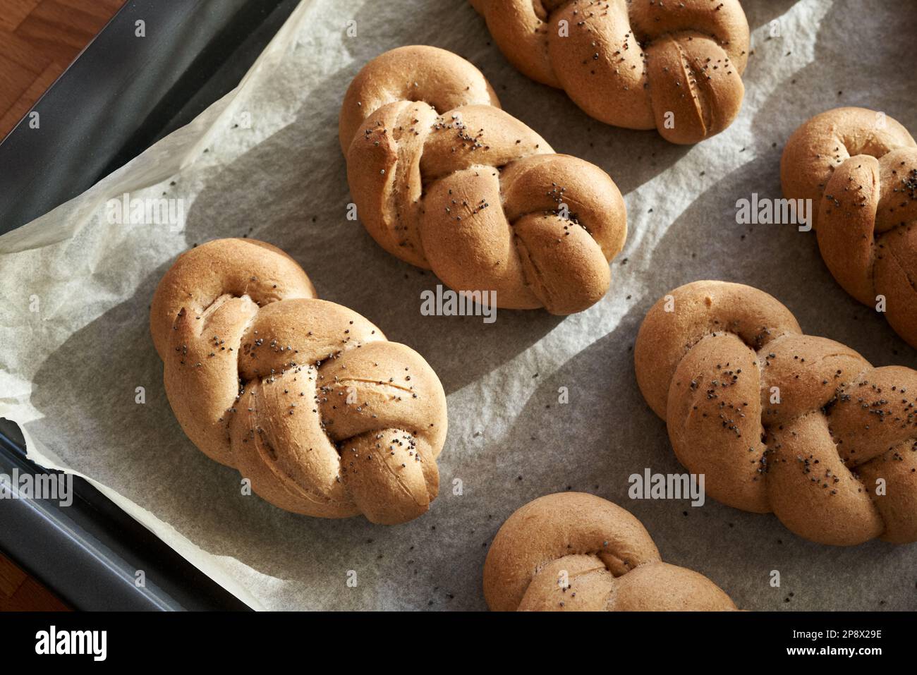 Homemade braided bread rolls or buns made from whole grain spelt flour ...