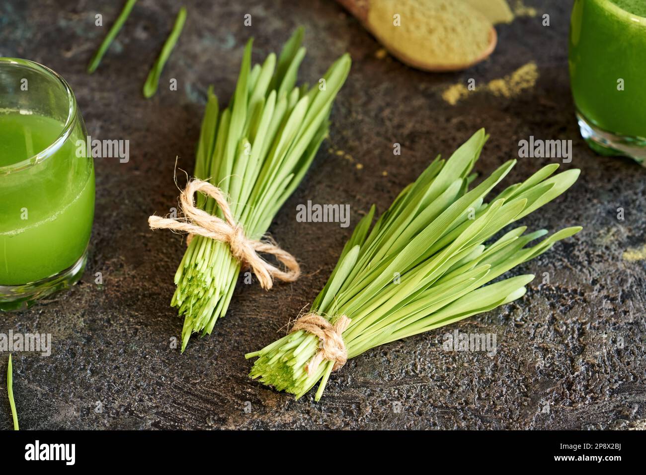 Two bundles of fresh barley grass with green juice and powder Stock ...