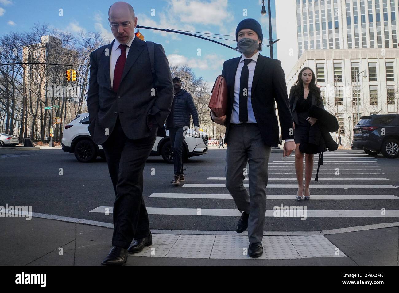 Roger Ng, second from left, a former Goldman Sachs banker, leaves ...