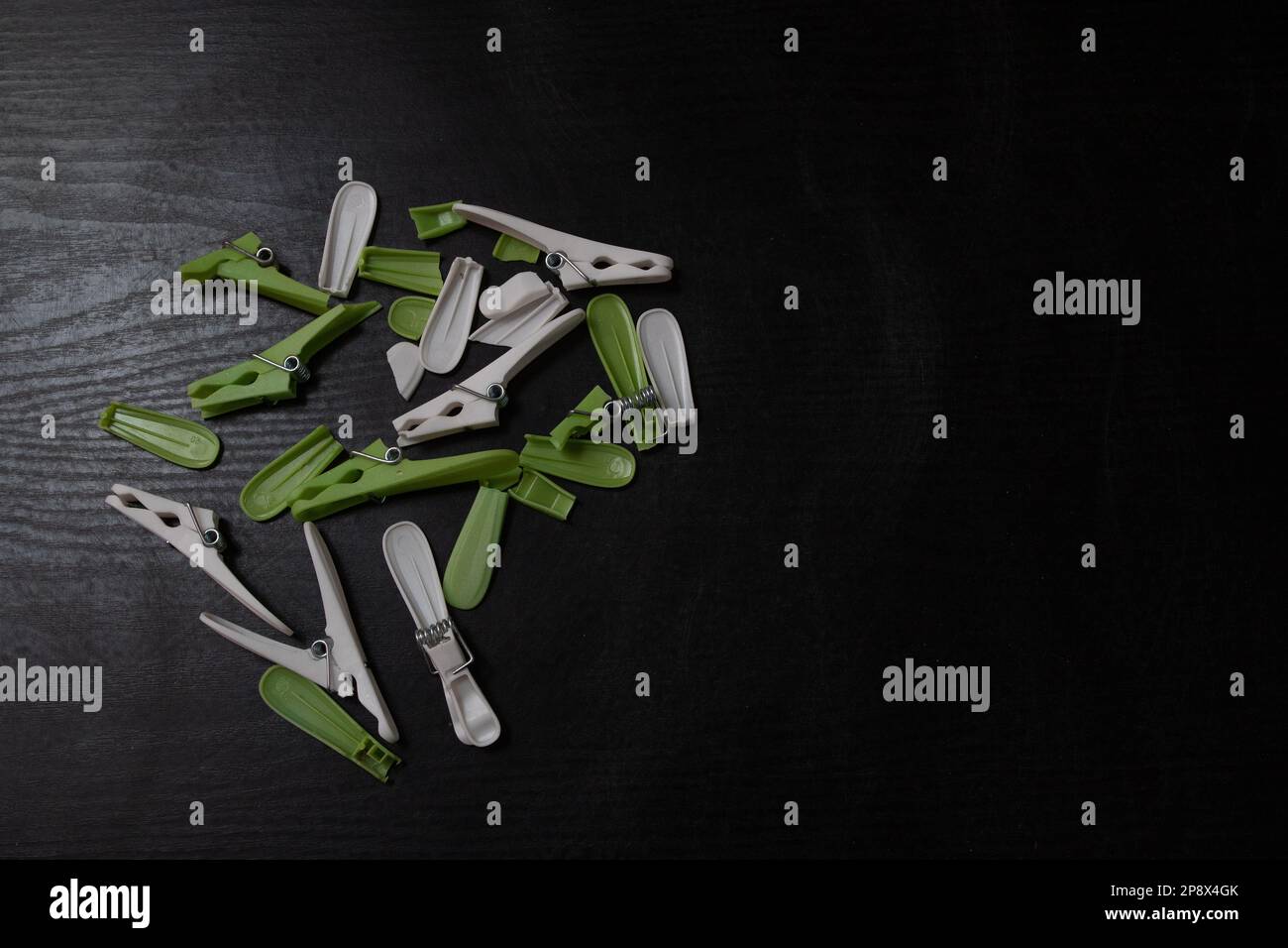 A selection of green and white plastic clothes pegs that because they ...