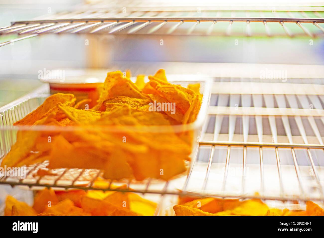 fresh potato chips in a plastic container on the counter, horizontal ...