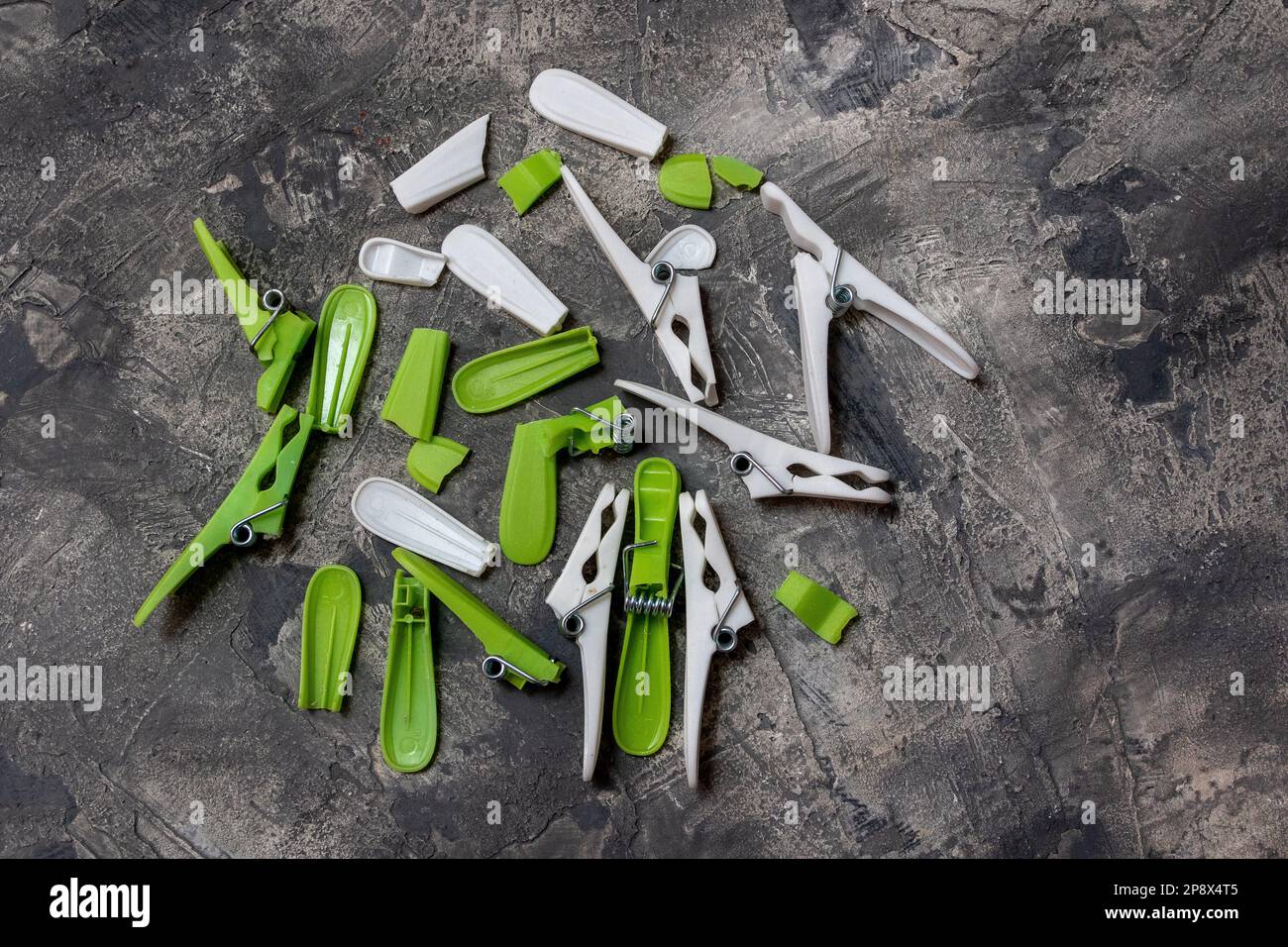 Remains of plastic clothes pegs cheaply made so they snap and break in ...