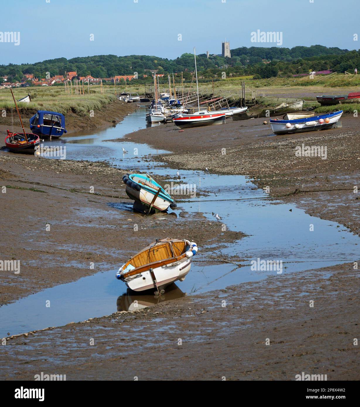 Tidal creek between Blakeney and Morston Quay at low tide with boats ...