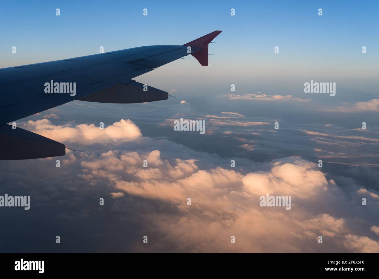 View from the airplane window. Clouds under the wing Stock Photo - Alamy