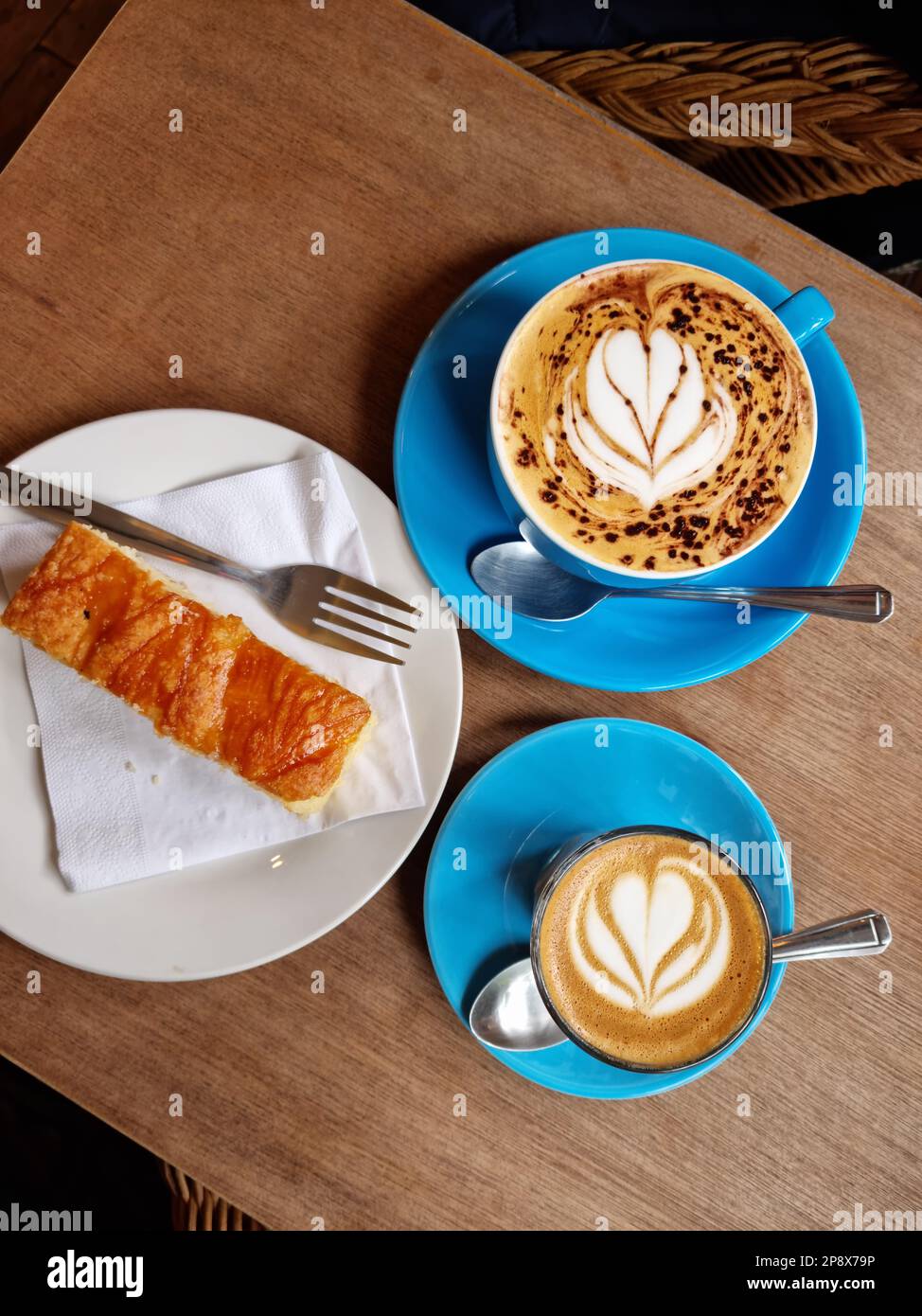 Top view of decorated cups of coffee (coffee art) and slice of lemon ...
