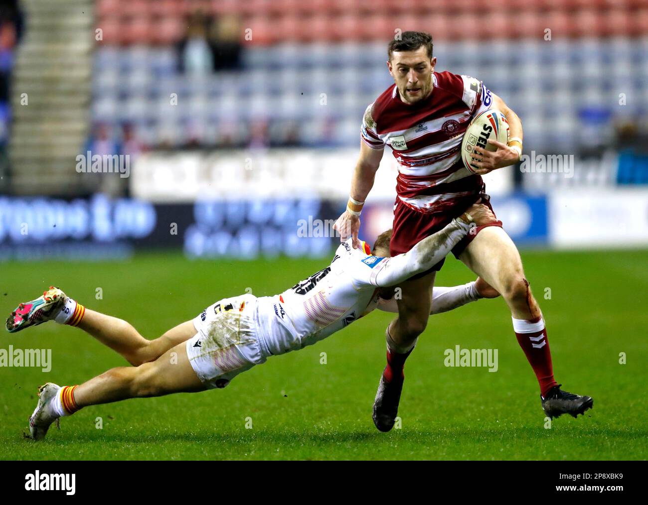 Wigan Warriors' Jake Wardle is tackled by Catalans Dragons' Ugo Tison ...