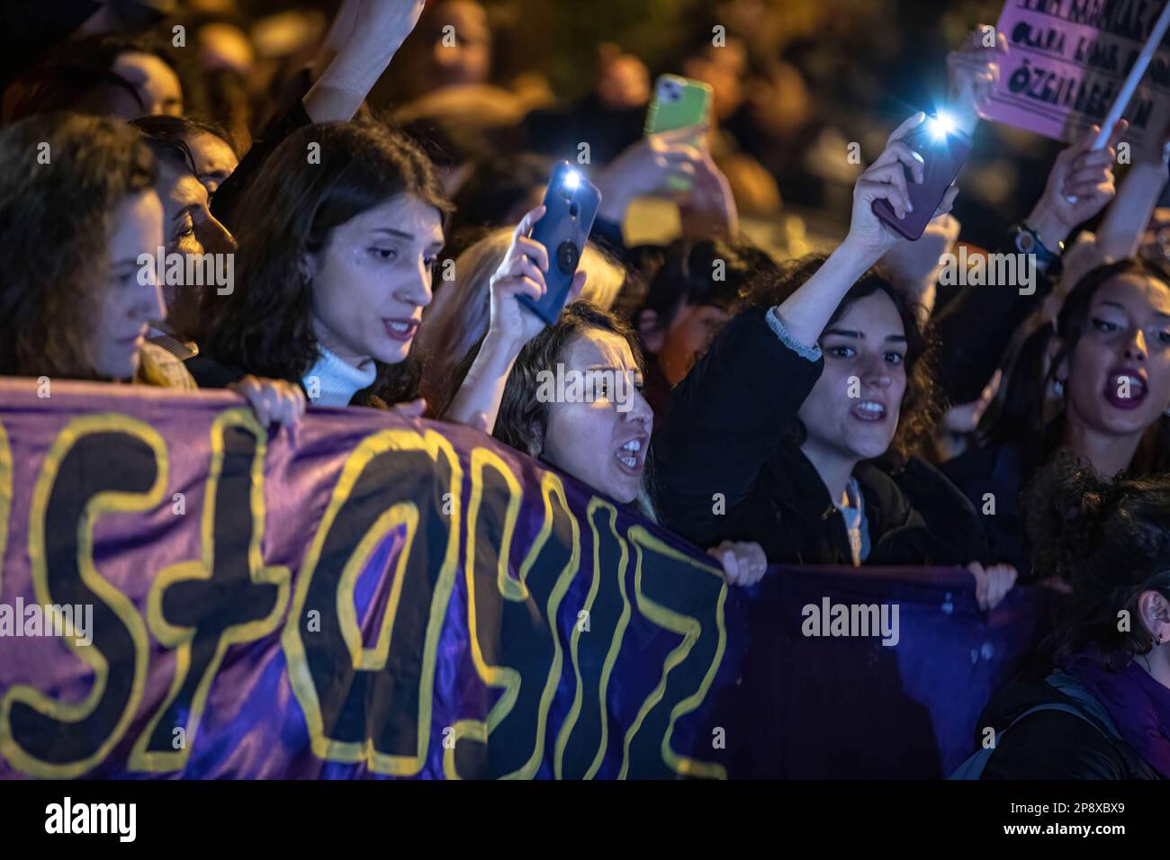 Protesters light-up cell phones and shouting slogans during the ...