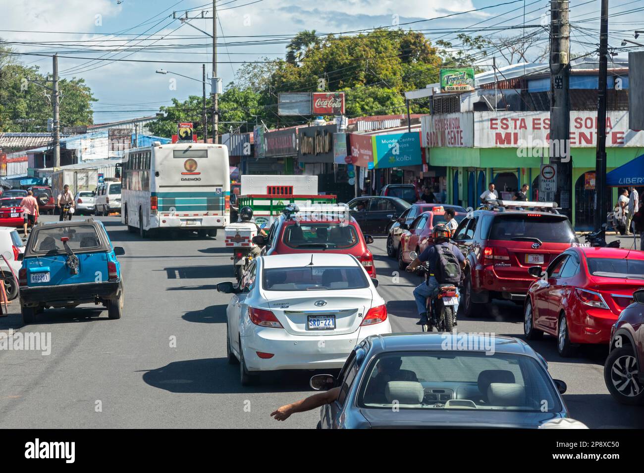 Cariari, Costa Rica - Cars, motorcycles, and buses on the street of ...