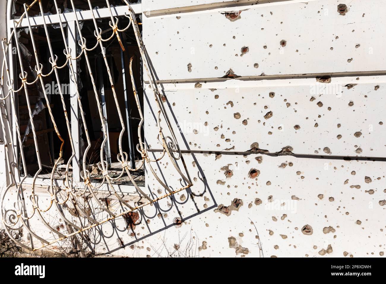 Building wall showing damage from shrapnel from burst shells in the ...