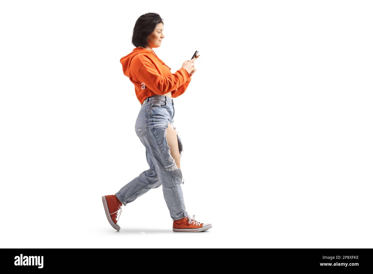 Full length profile shot of a gen z female using a smartphone and ...
