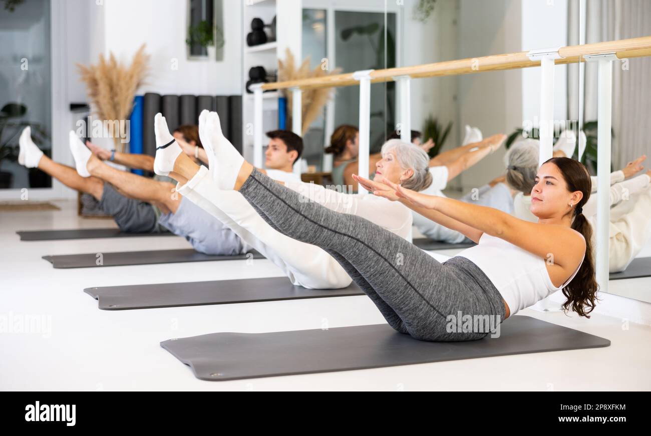 Group of different people doing exercises in gym Stock Photo - Alamy