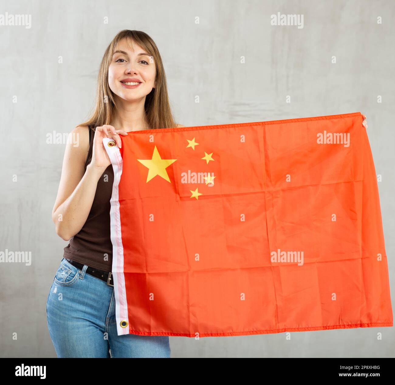 Happy woman posing with flag of China in studio Stock Photo - Alamy