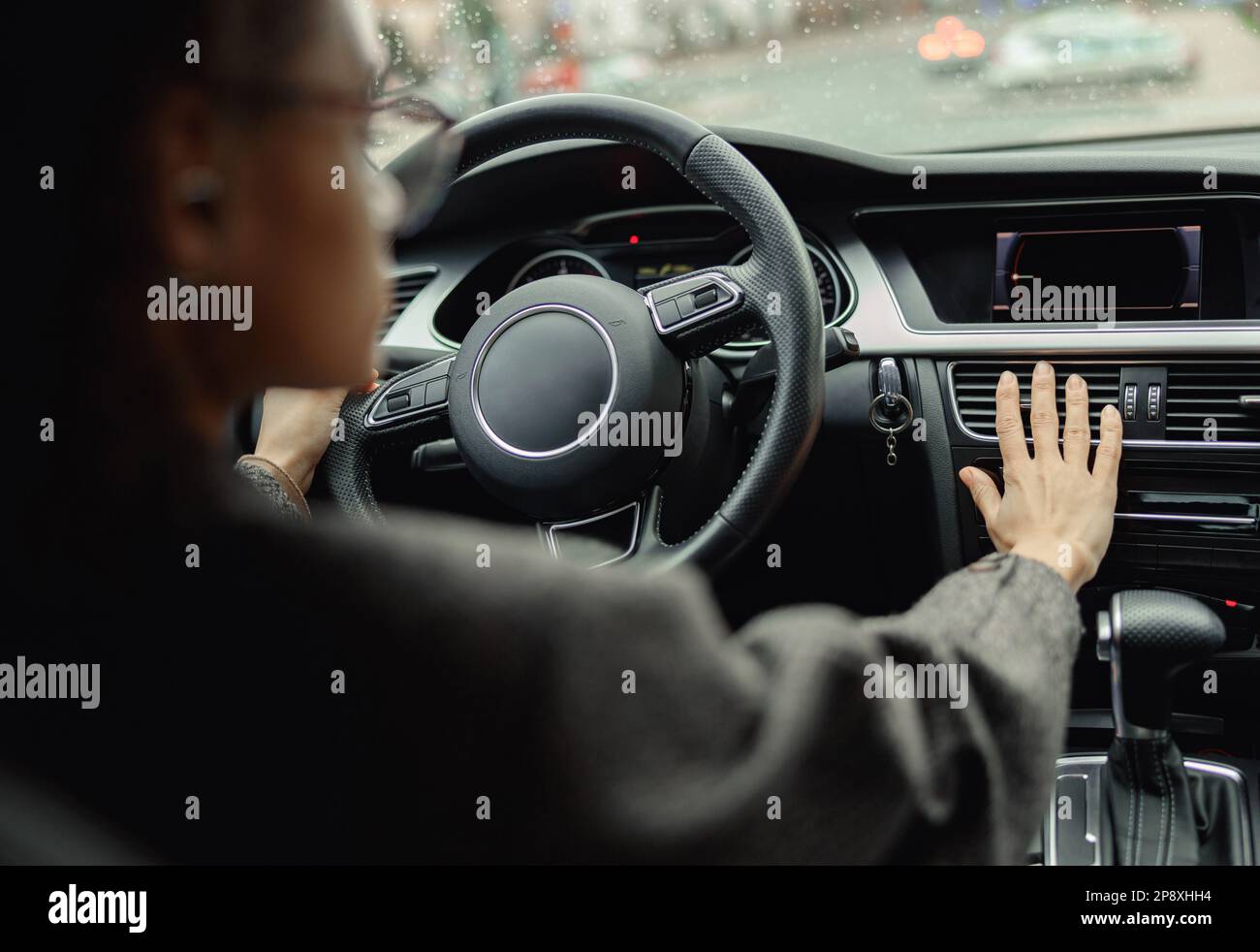 Female driver is controlling car air conditioning system grid panel on ...