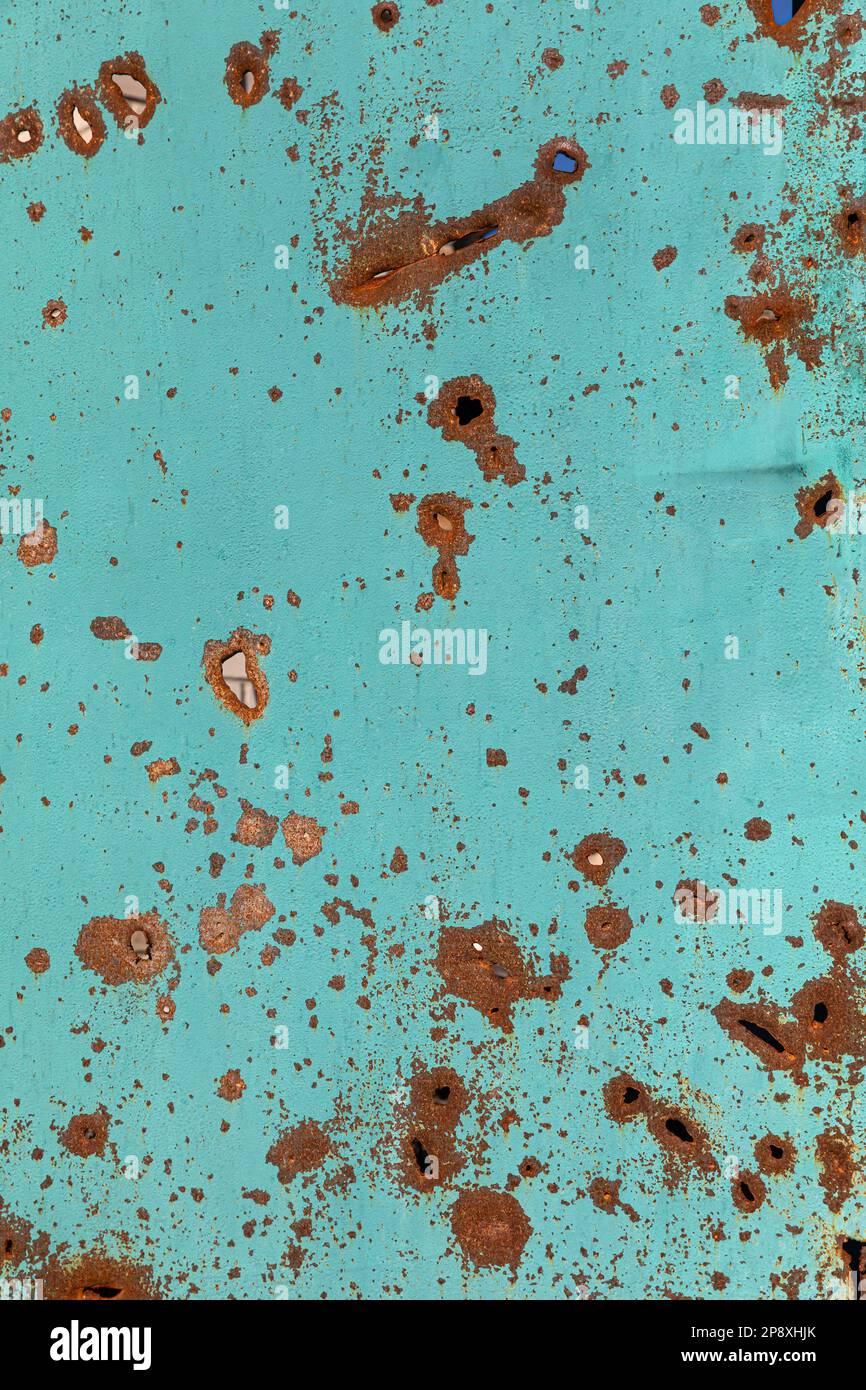 A metal gates is covered with splinter marks from exploding shells in ...