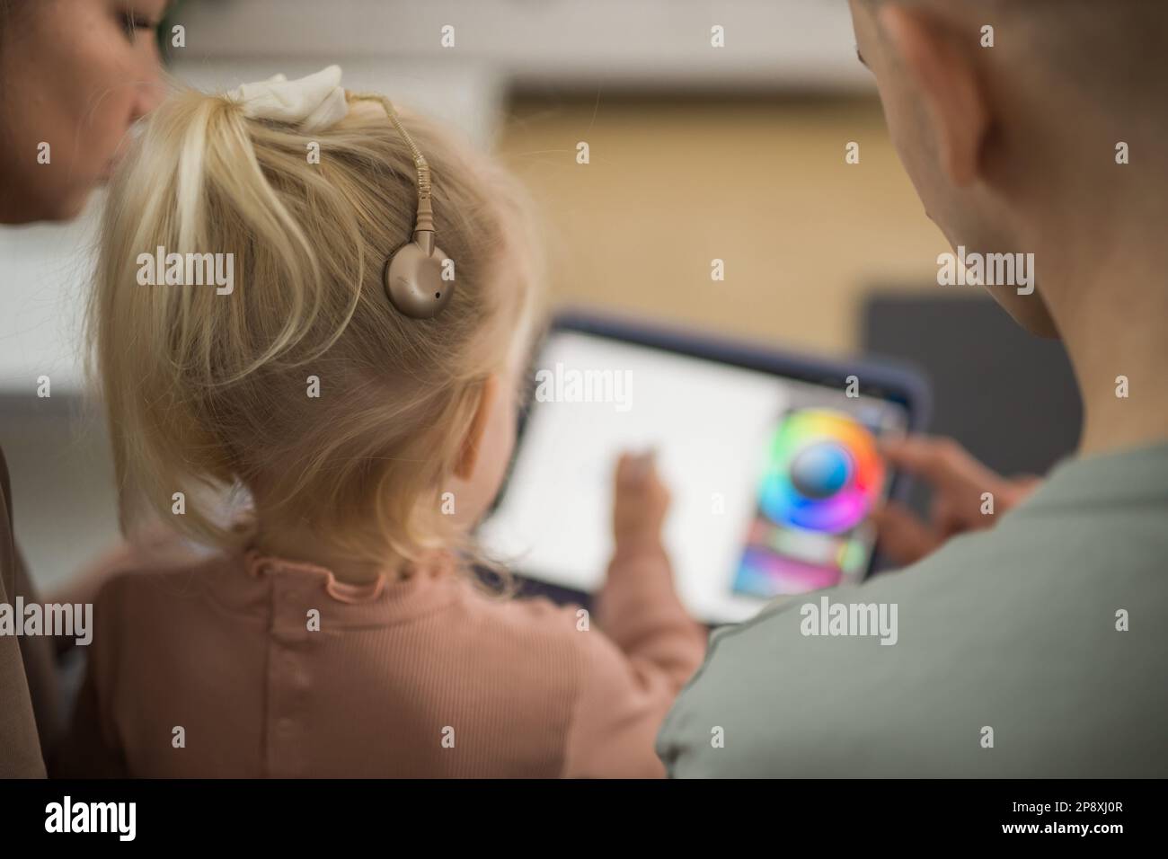 Deaf child girl with cochlear implant studying to hear sounds and have ...