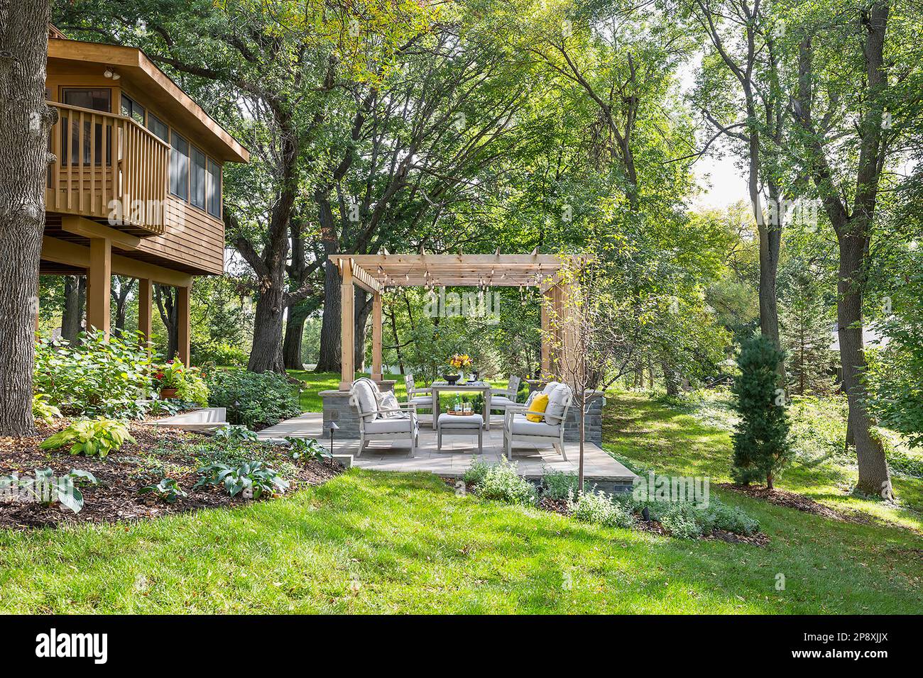 Pergola and bluestone patio in backyard creates outdoor space for ...