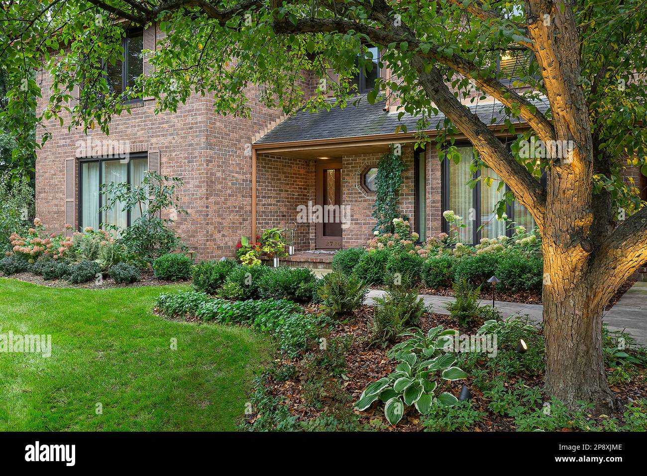A house with a large yard that has been landscaped with new steps ...