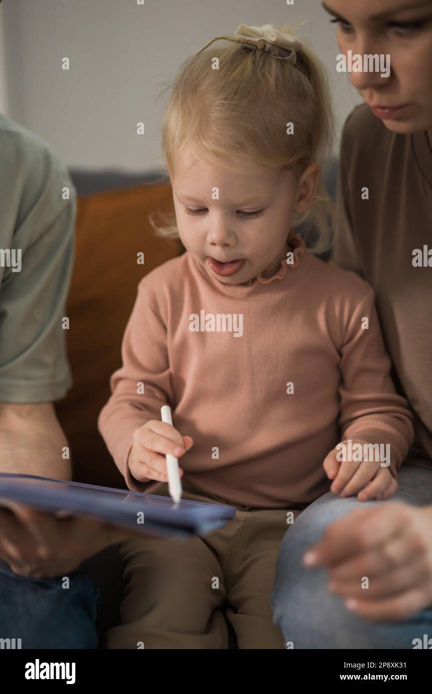 Deaf child girl with cochlear implant studying to hear sounds ...