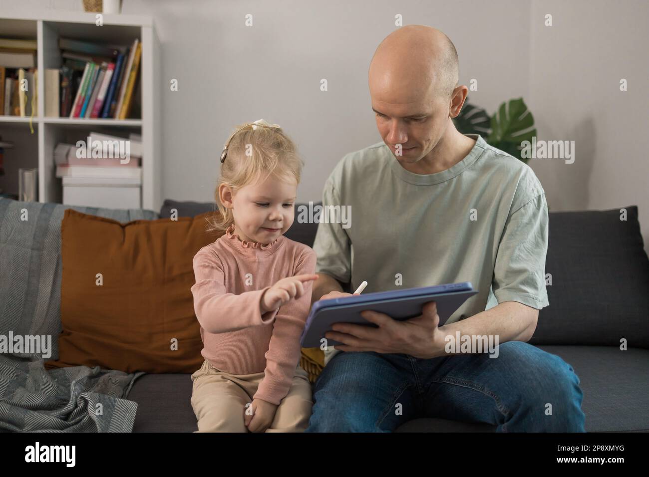 People with cochlear implant system. Kid study to hear with her father ...