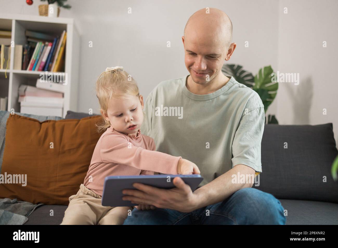 People with cochlear implant system. Kid study to hear with her father ...