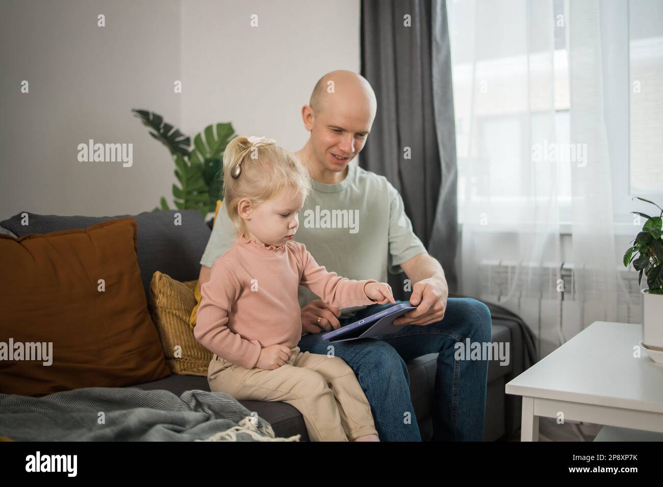 People with cochlear implant system. Kid study to hear with her father ...