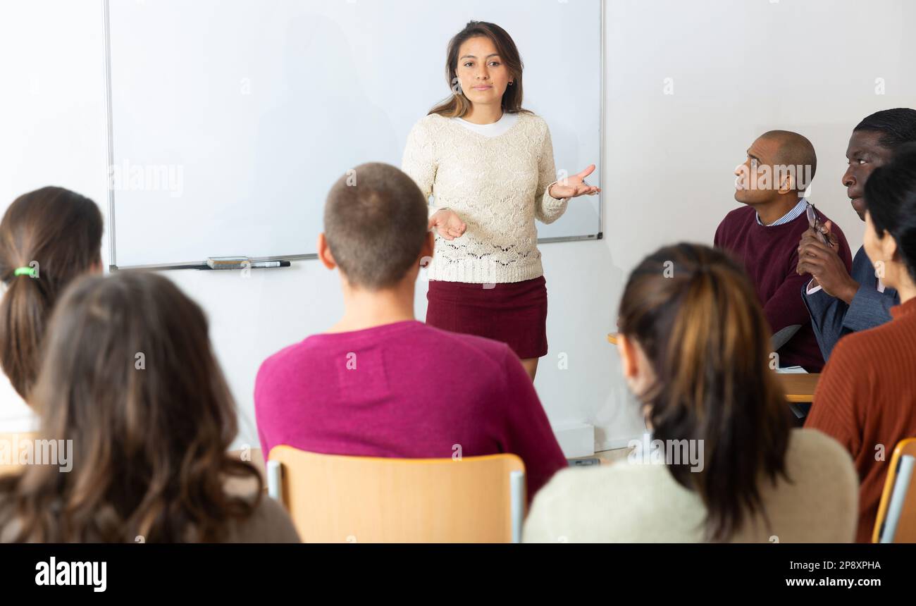 Female high school teacher teaching lesson Stock Photo - Alamy