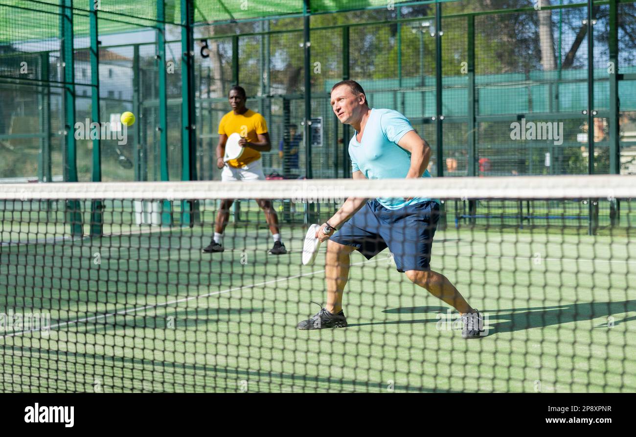 Man playing padel tennis on court Stock Photo - Alamy