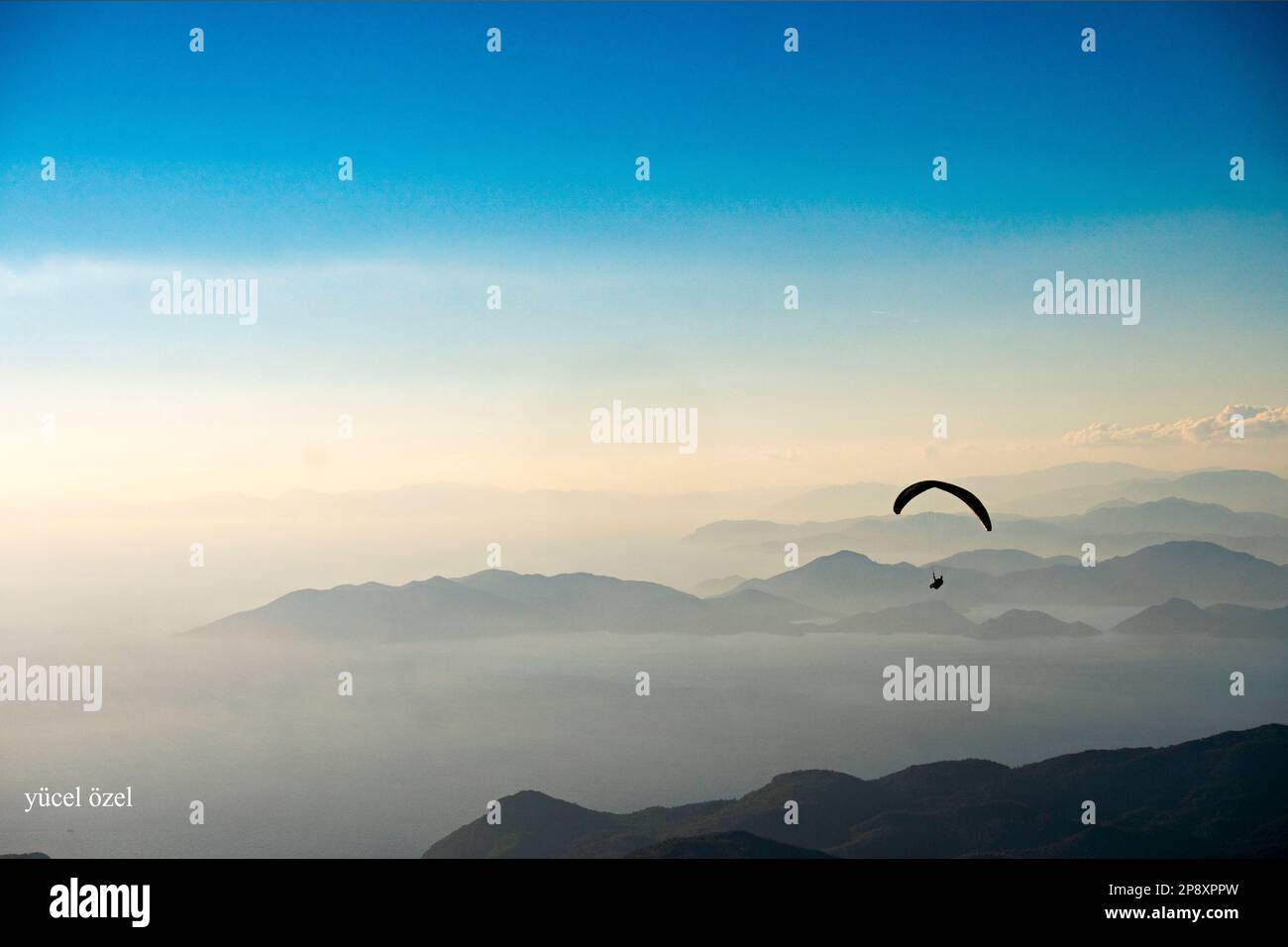 Paragliding with sunset Stock Photo - Alamy